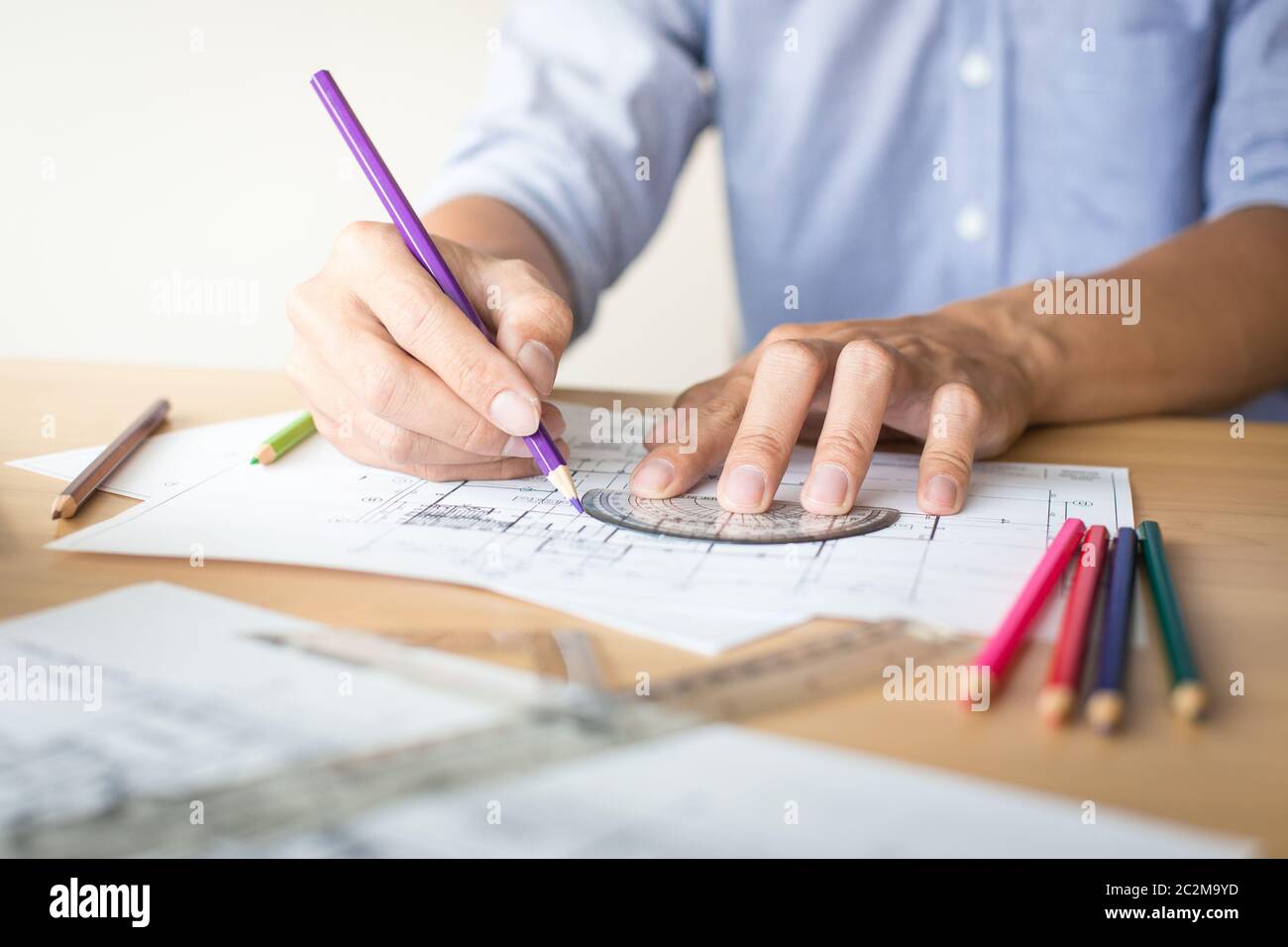Creative architect projecting on the big drawings in the dark loft ...