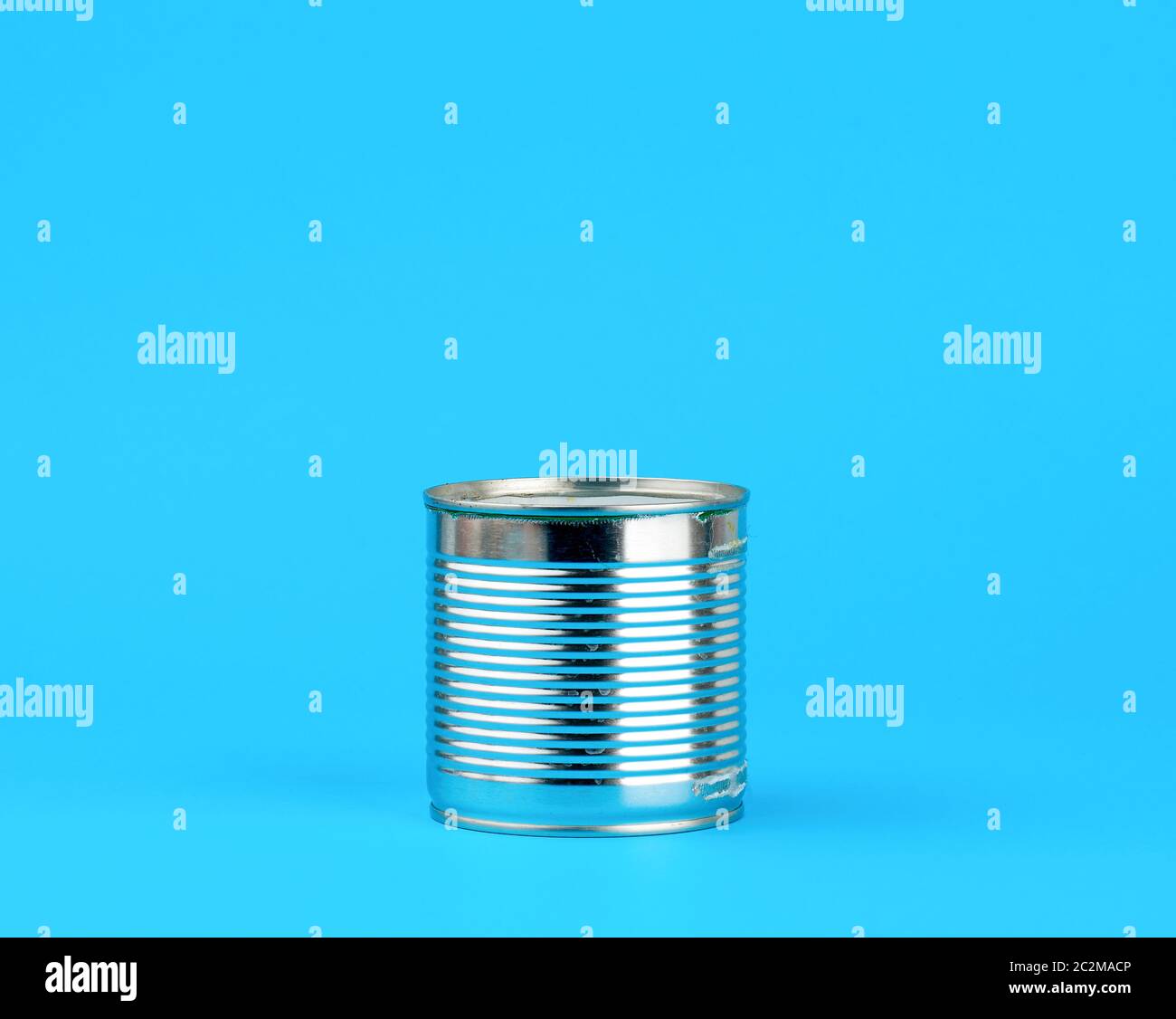 closed hard iron can for food preservation on a blue background, copy ...