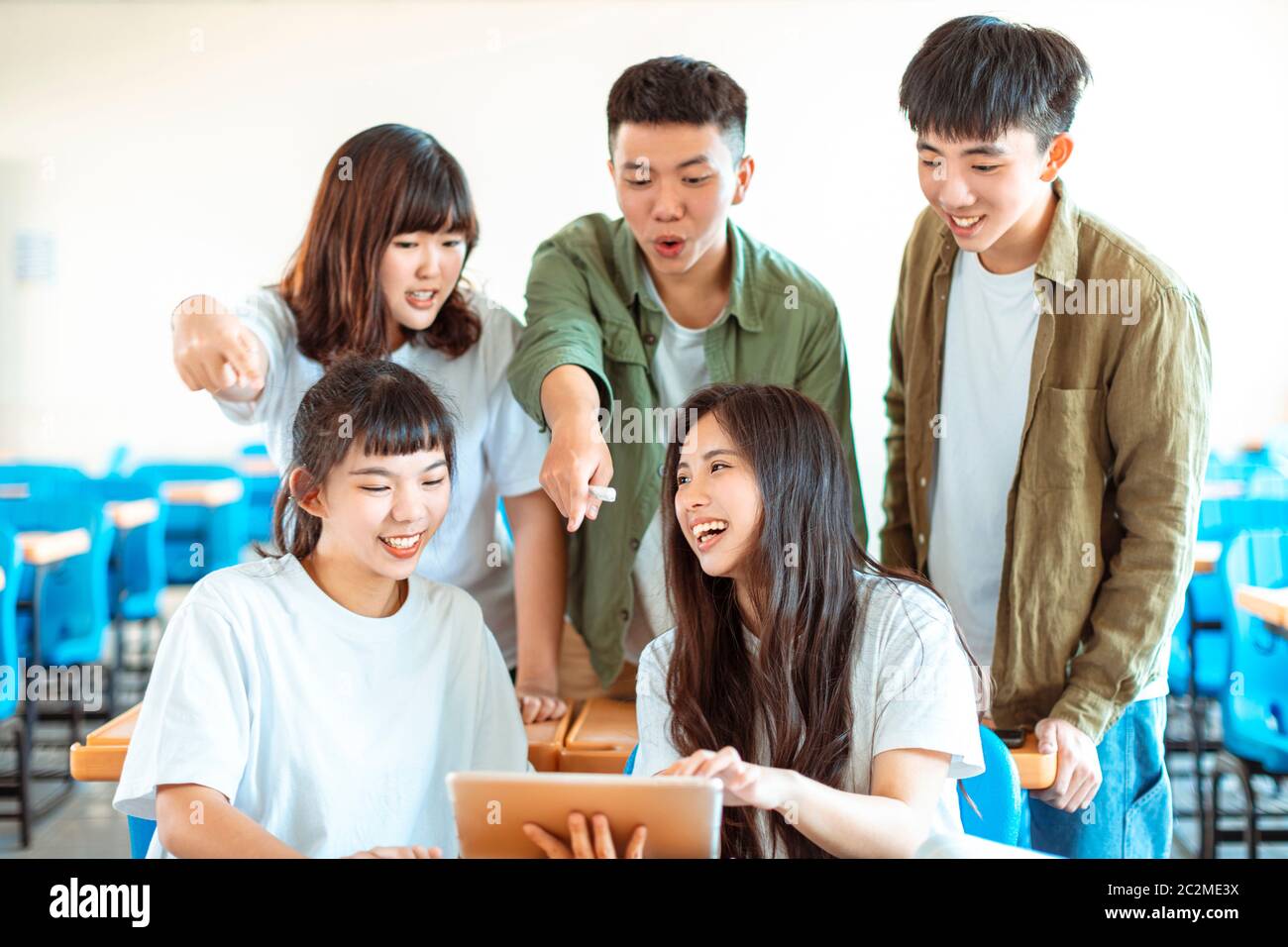 collage Student discuss with Classmate in Classroom Stock Photo - Alamy
