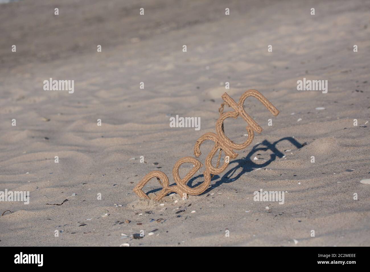decorative sign with word beach in the sand on a sunny day Stock Photo ...