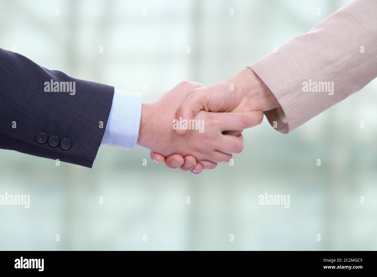Business men in a handshake at the office Stock Photo - Alamy