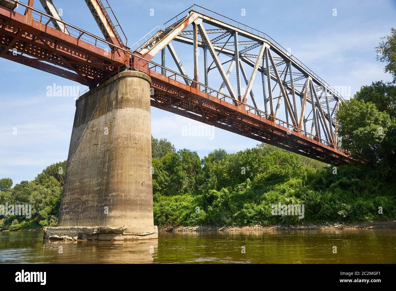 Old railway bridge over a river, rusty metal grid Stock Photo - Alamy