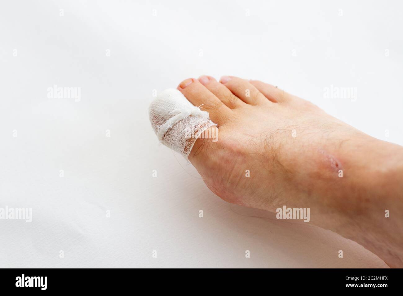 bandaged on an injured finger thumb toe foot on white background Stock ...