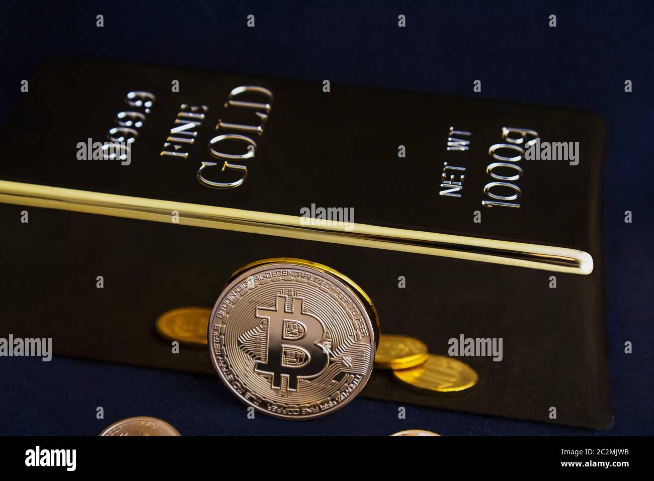 Bitcoin cryptocurrency and gold bar on a black background Stock Photo ...