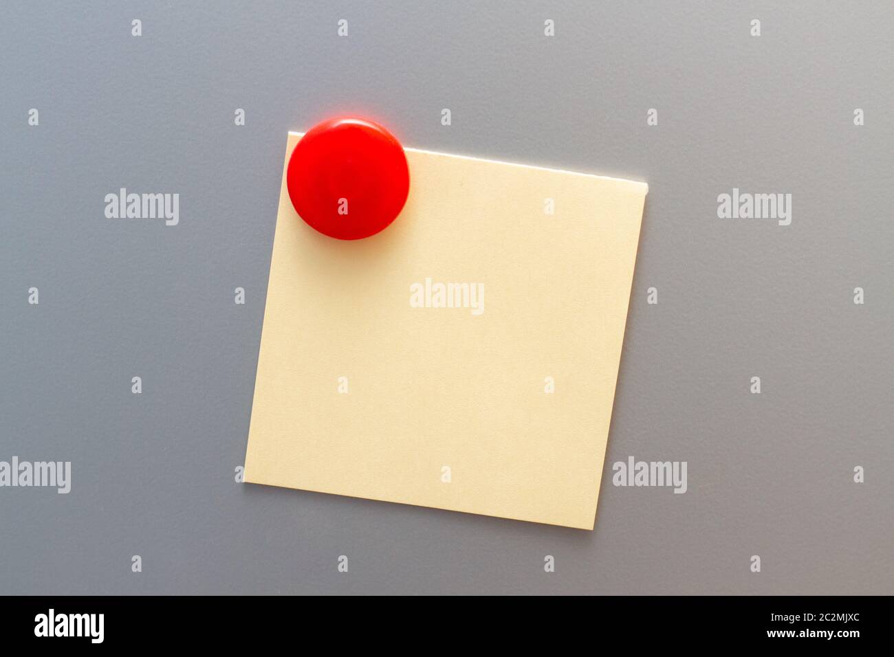 yellow note with red pin on fridge, close up Stock Photo - Alamy