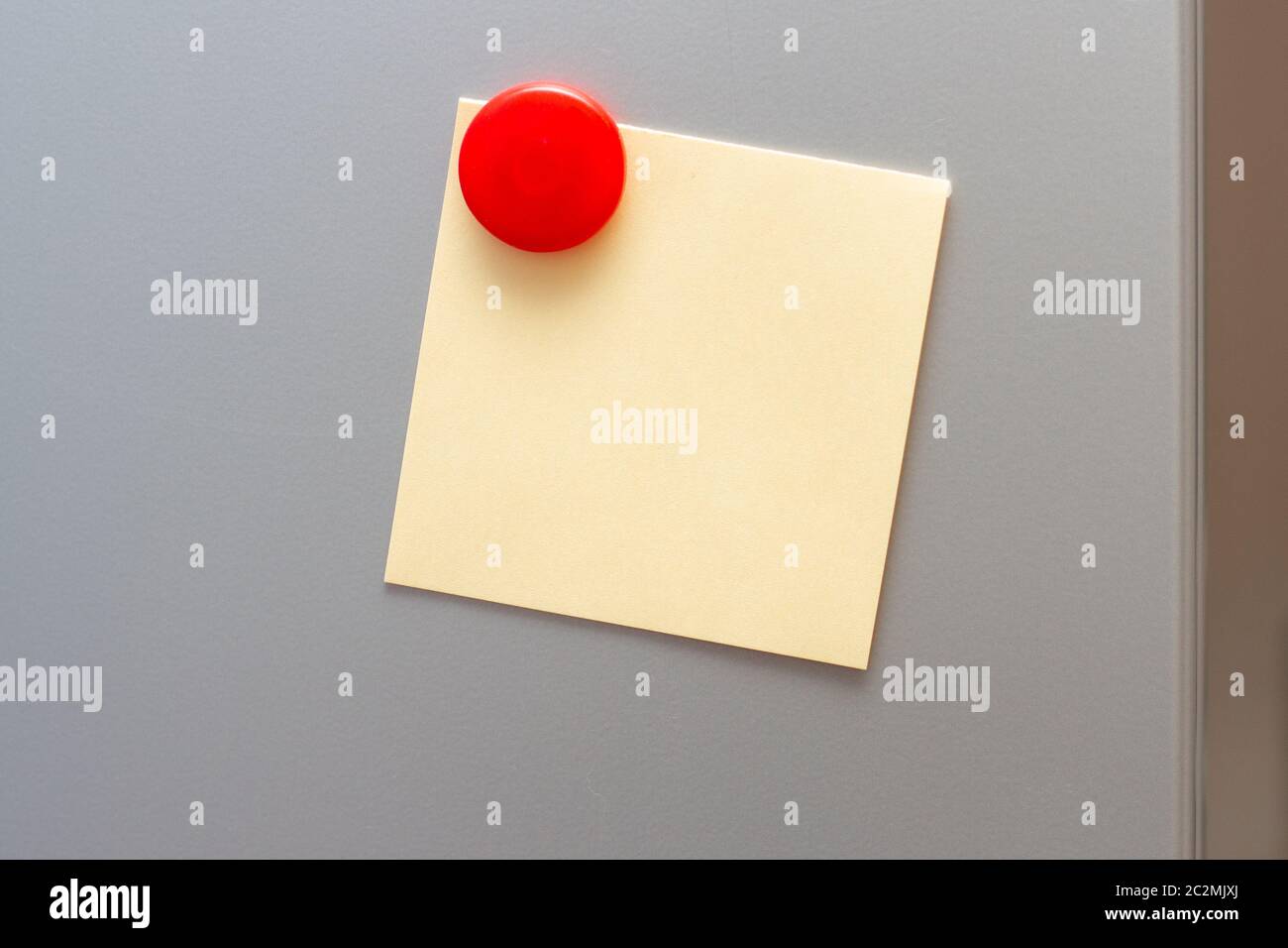 Yellow empty notes attached red magnet on fridge Stock Photo - Alamy