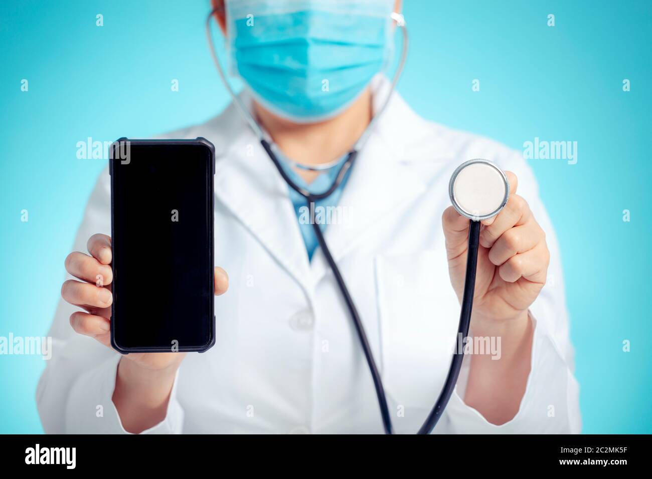 doctor with stethoscope and smart phone in hand for medical exam ...