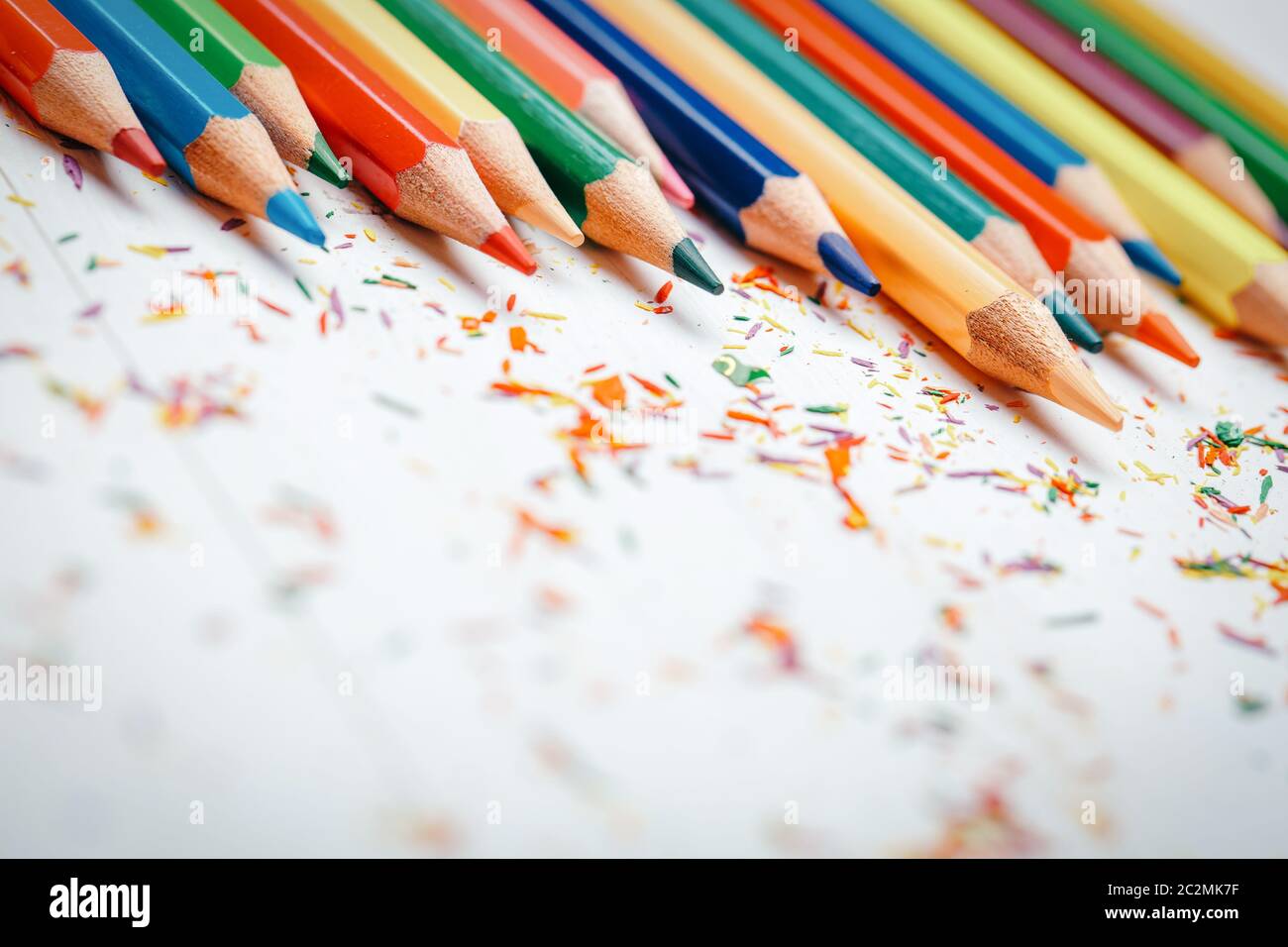 Pile of sharp coloured drawing pencils on table. Background ready for ...