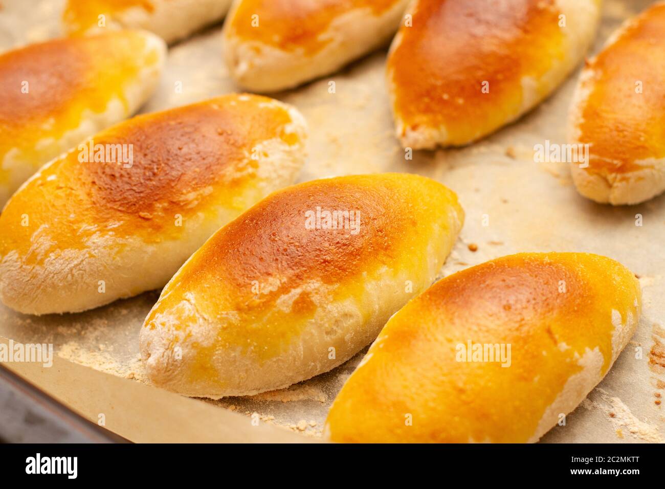 oven-baked pastry pies on baking paper Stock Photo - Alamy