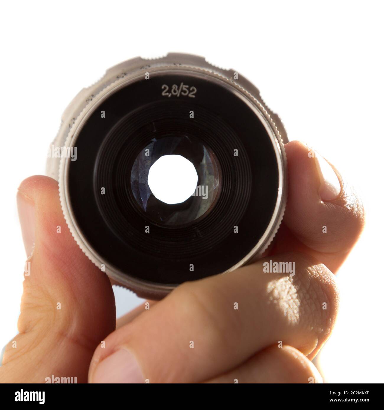 Hand holding retro camera lens on white background Stock Photo - Alamy