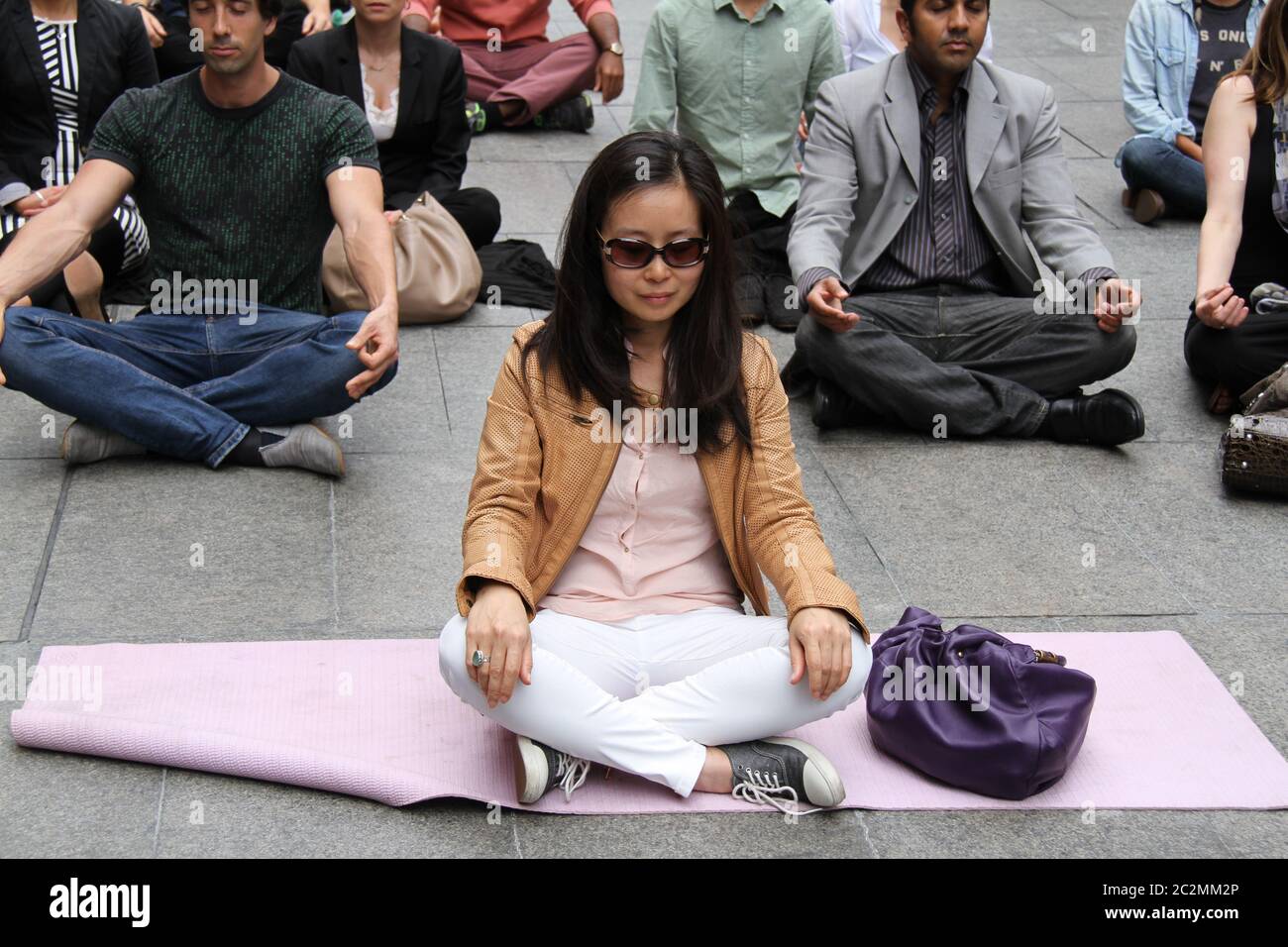 People sit down on the street in what appeared to be a yoga flash mob ...