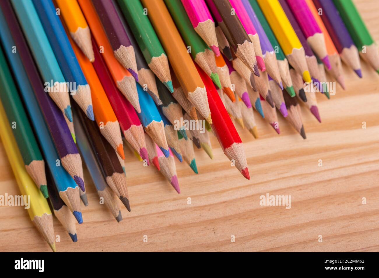 Wooden colorful pencils, on wooden table Stock Photo - Alamy