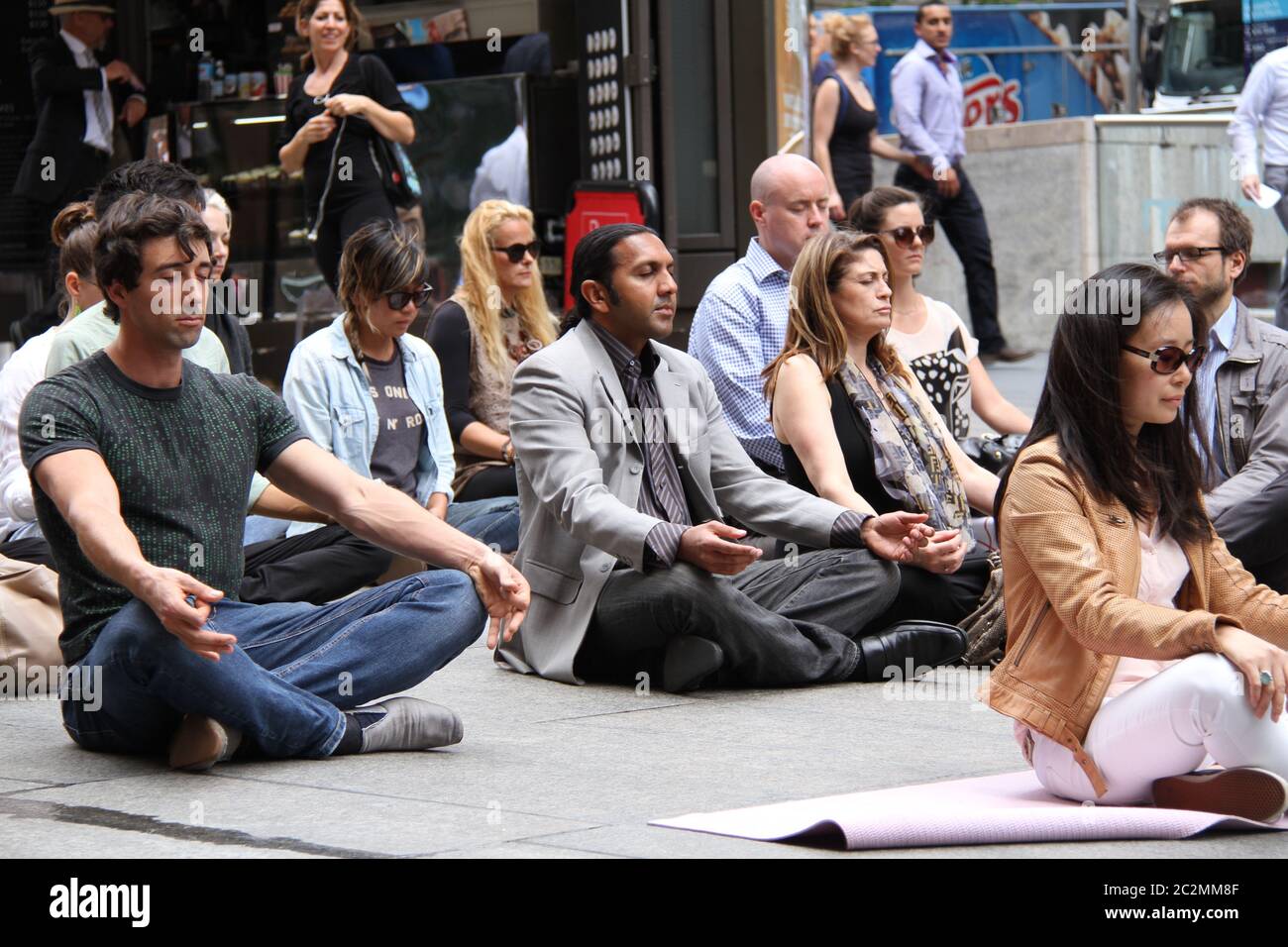 People sit down on the street in what appeared to be a yoga flash mob ...