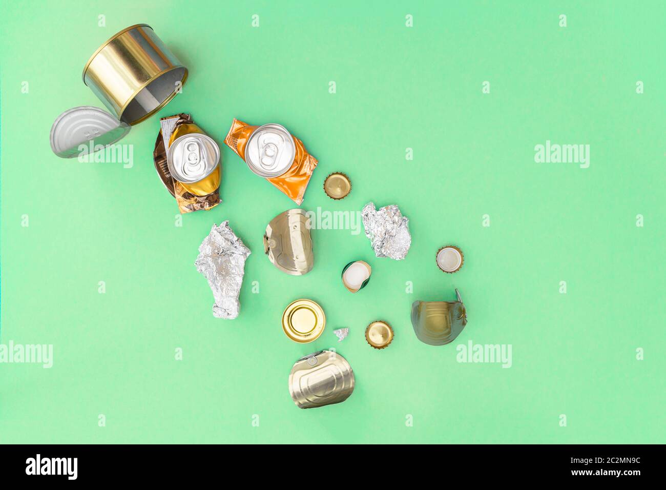 Metal garbage flies out of a metal can on the blue background. Waste ...