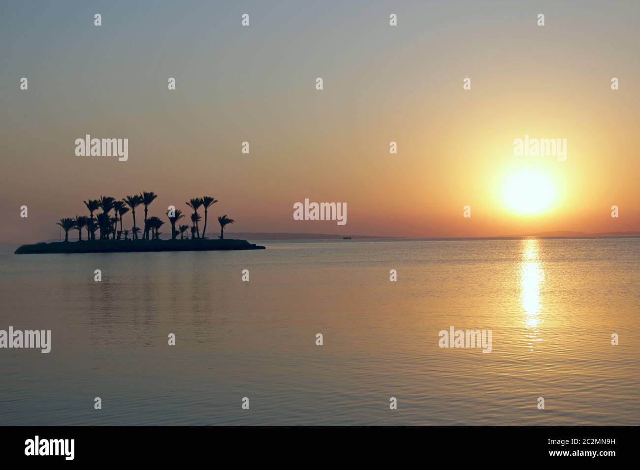 Sunrise over sea with tropical island. Sun riseing over ocean ...