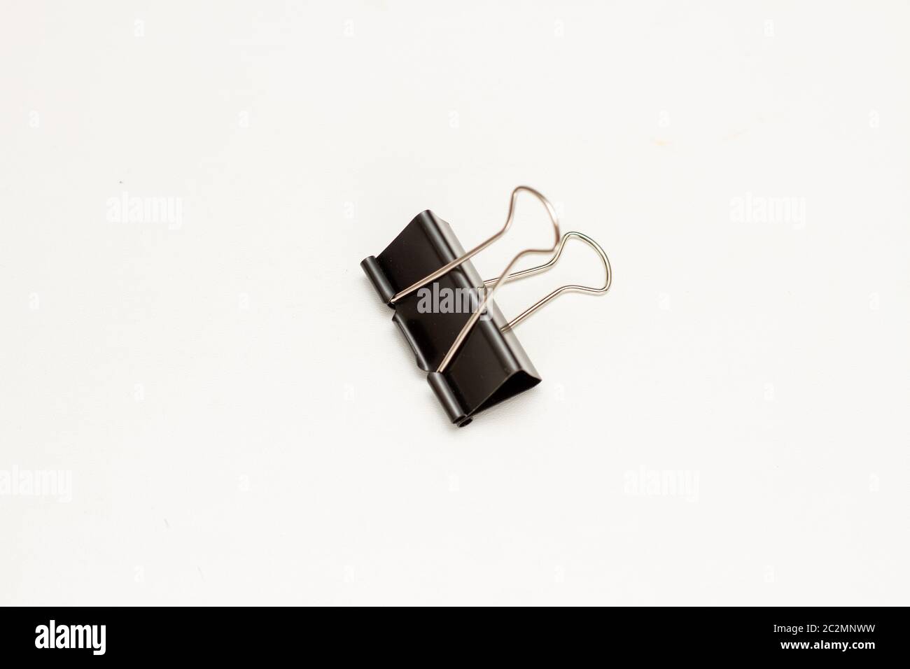 One black binder clip for papers isolated Stock Photo - Alamy