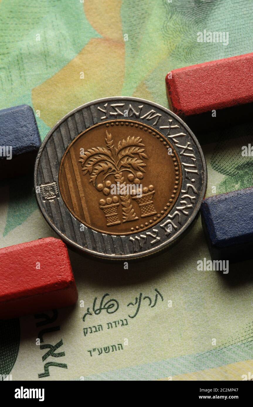 Israeli coin with magnets on banknote Stock Photo - Alamy