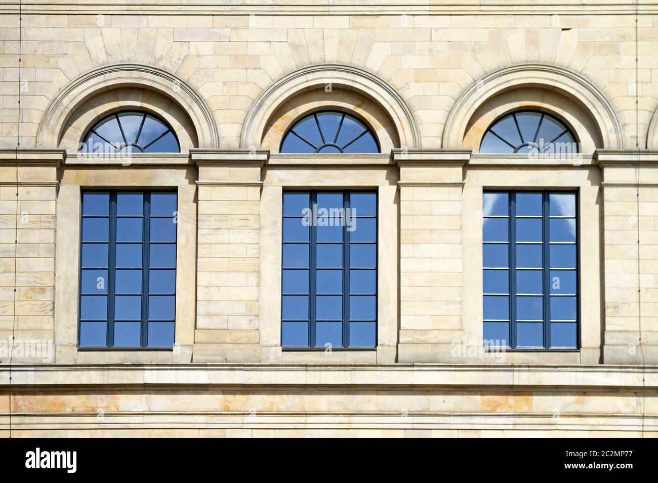Three arch blue windows at stone building Stock Photo - Alamy