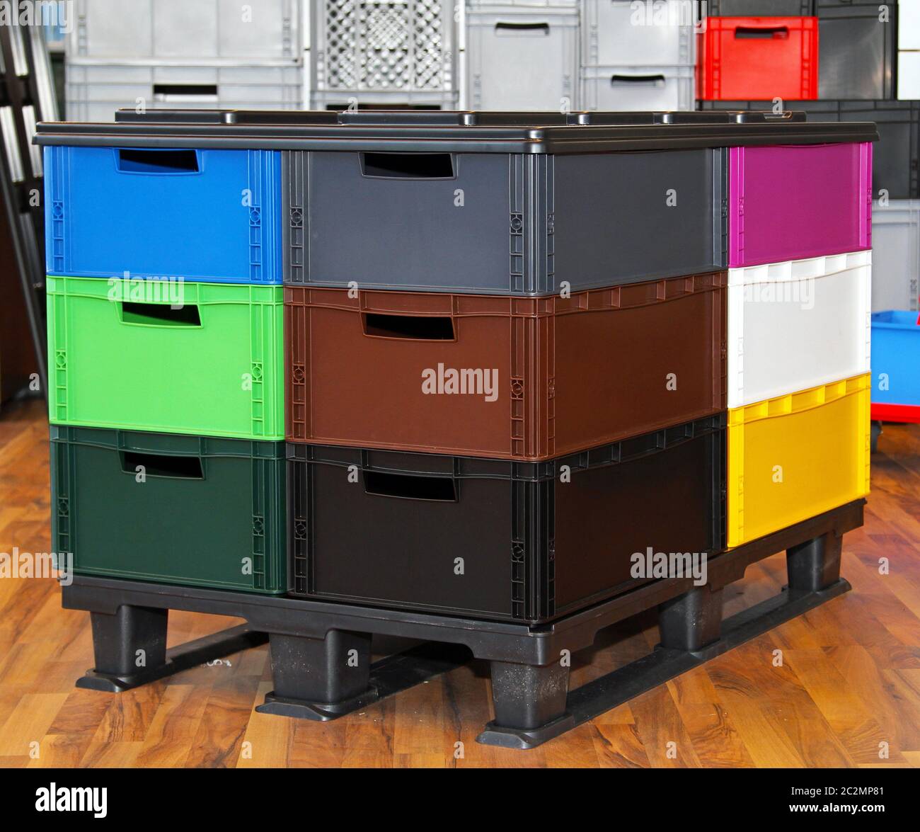 Color plastic crates and boxes at transportation pallet Stock Photo - Alamy