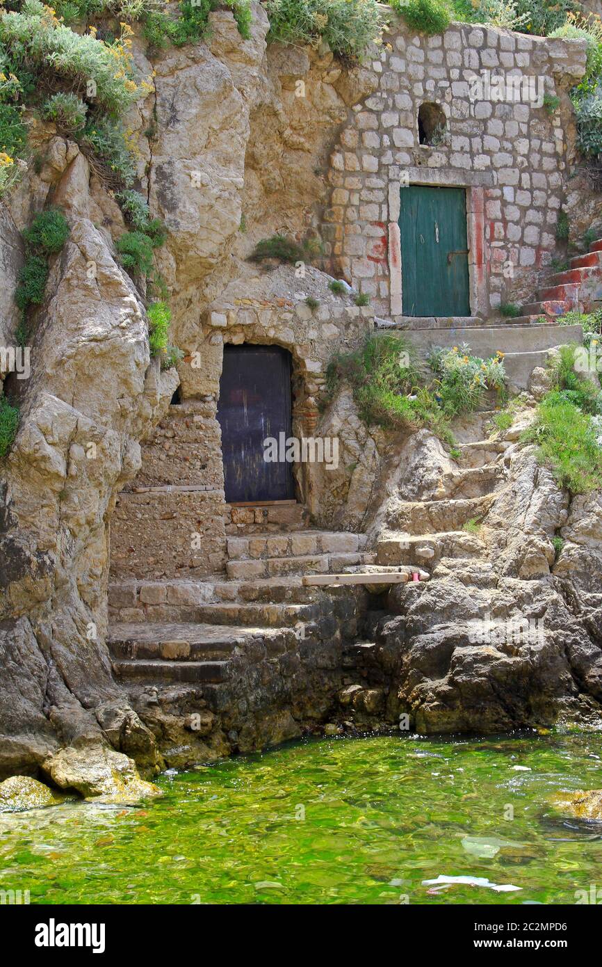 Two doors entrance to caves near the sea Stock Photo - Alamy