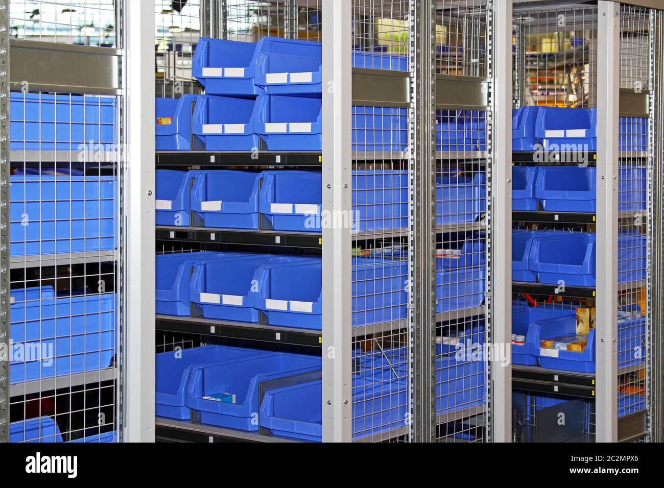 Blue plastic sort boxes in shelf Stock Photo - Alamy