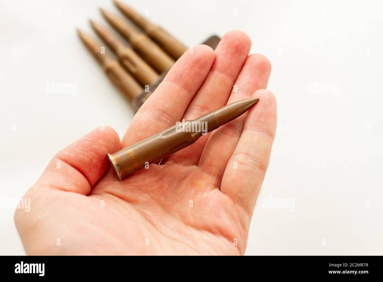 ammunition bullet for firearms on human hand on white background Stock ...