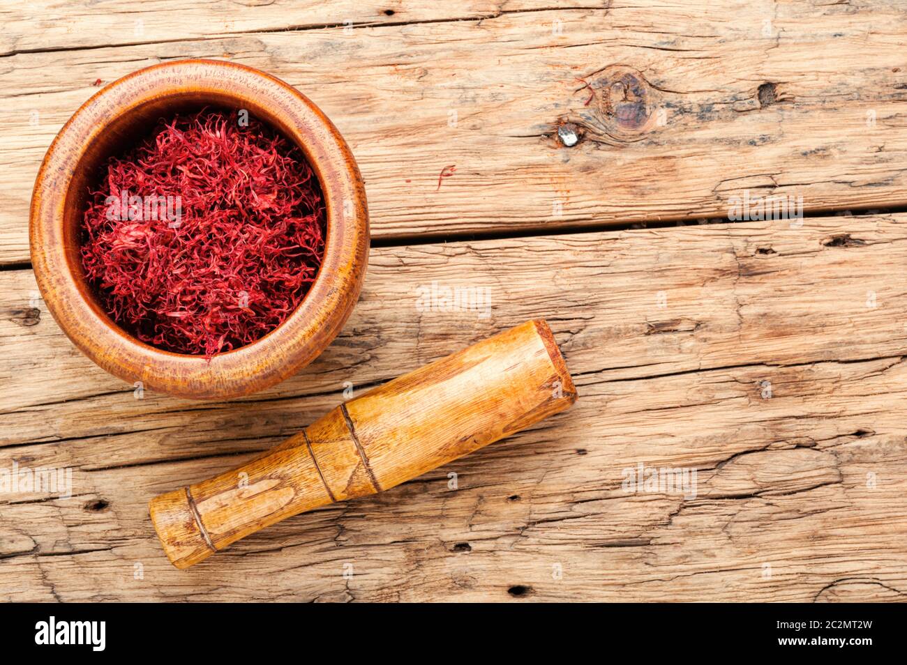 Raw organic red saffron spice on wooden background Stock Photo - Alamy
