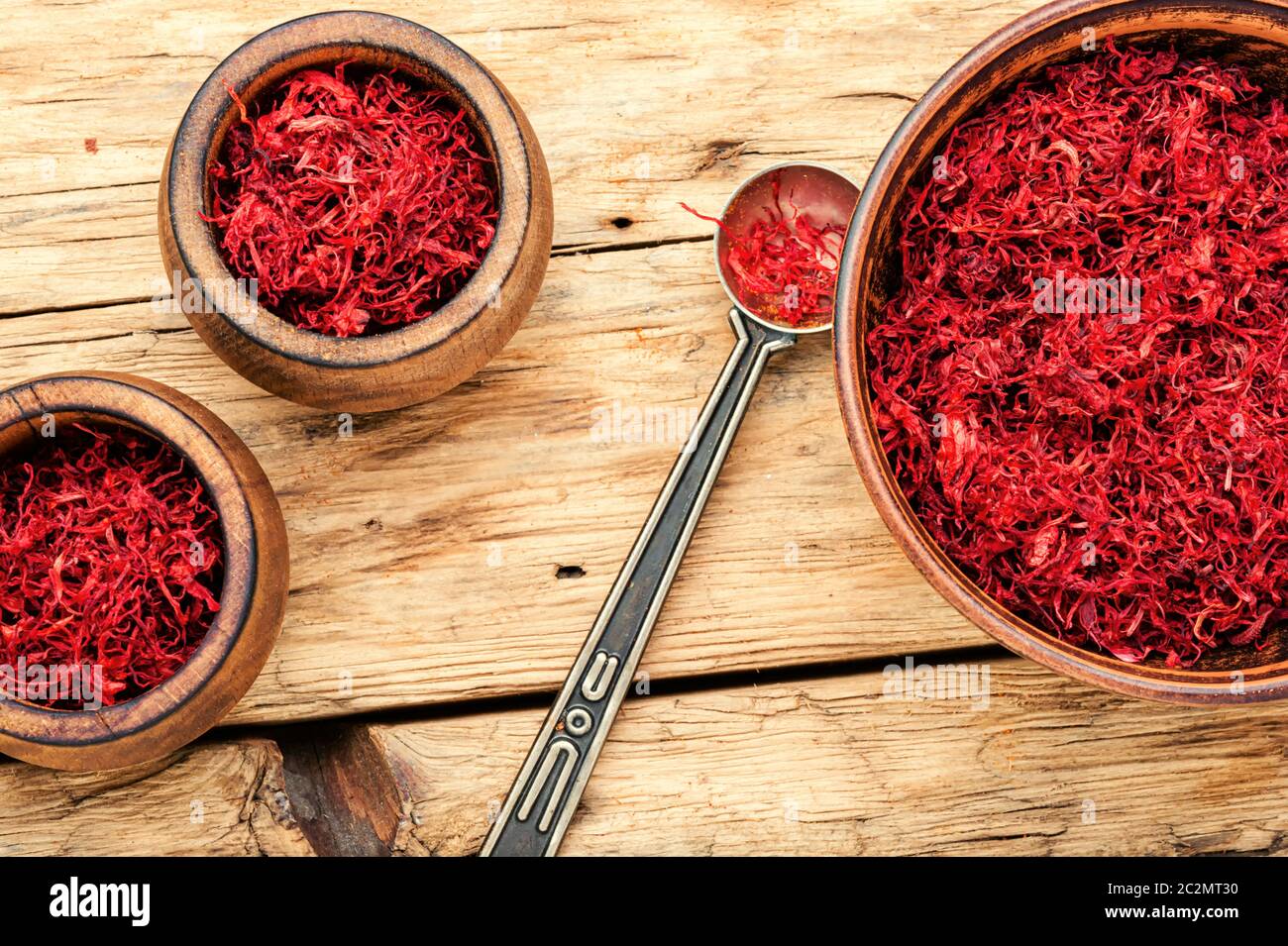 Raw organic red saffron spice on wooden background Stock Photo - Alamy