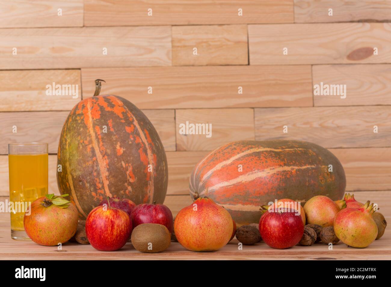 Autumn nature fruits concept. Fall fruits and orange juice, on a wooden ...