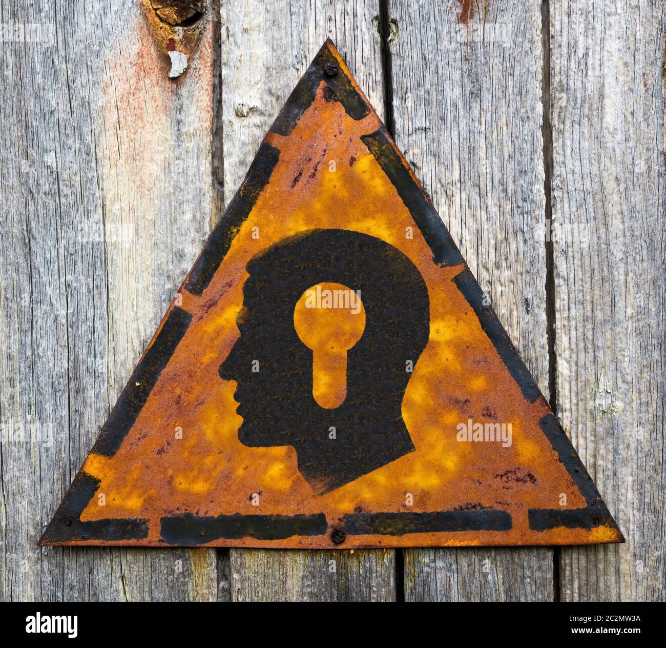 Profile of Head with a Keyhole Icon on Weathered Triangular Yellow ...