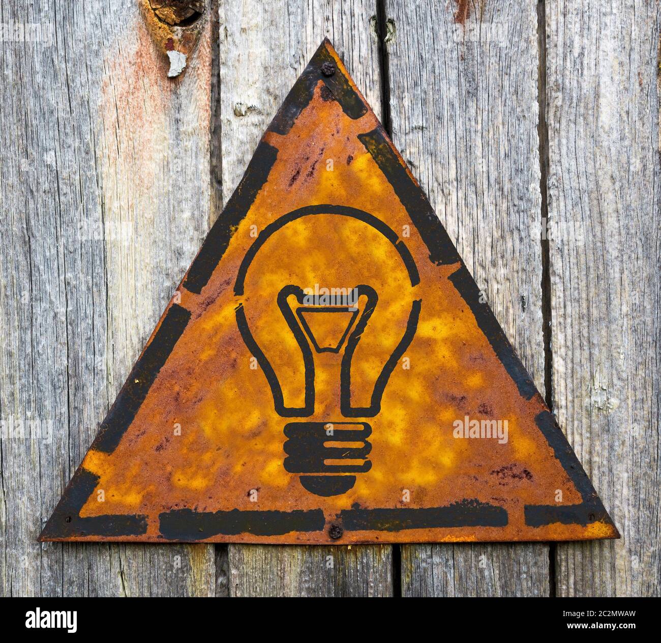 Light Bulb Icon on Weathered Triangular Yellow Warning Sign. Grange ...