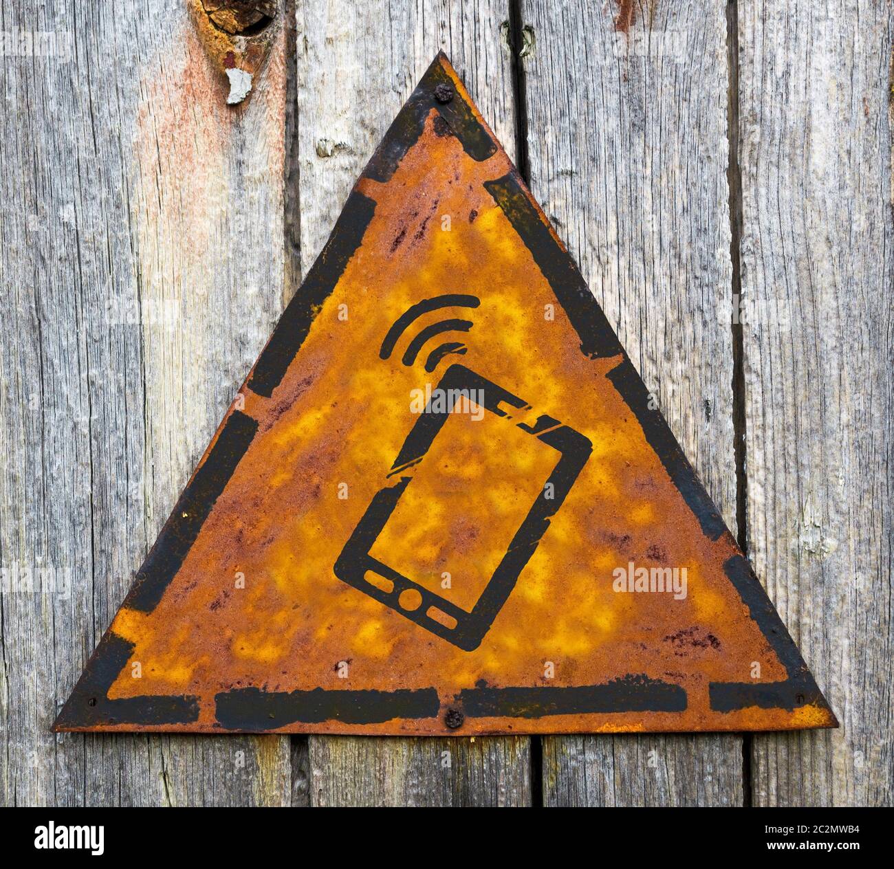 Smartphone Icon on Weathered Triangular Yellow Warning Sign. Grange ...