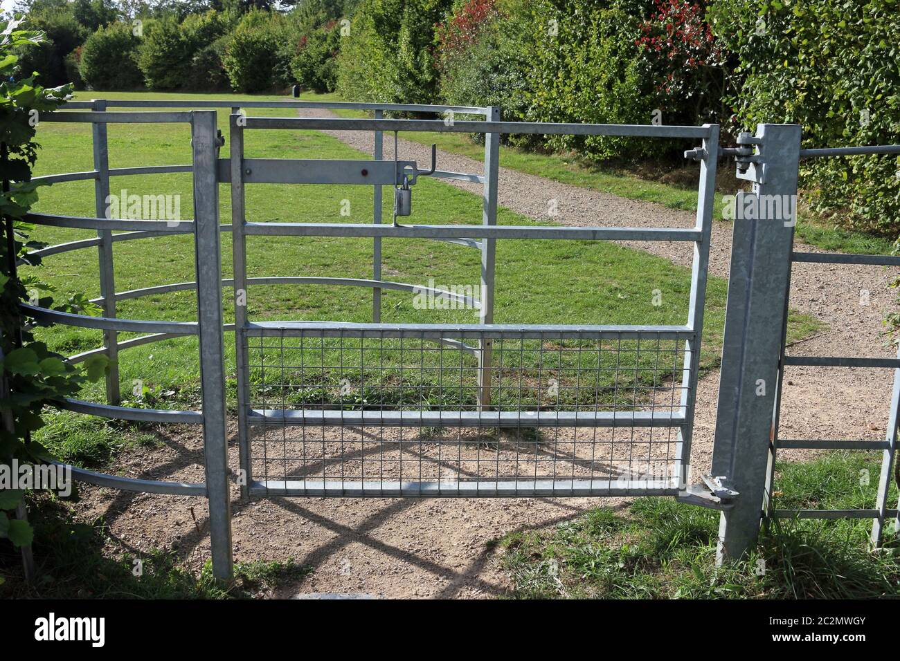Galvanised metal kissing gate at park entrance with a limestone ...