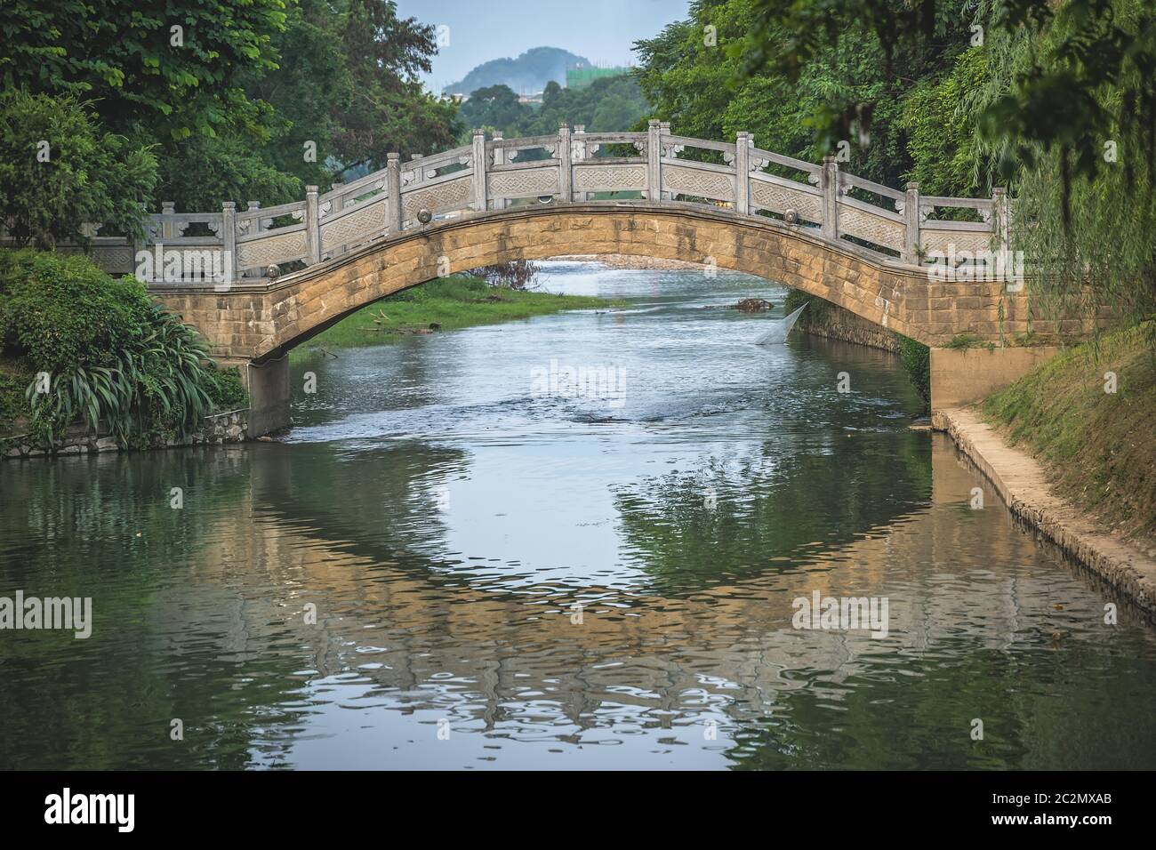 Small arched old bridge on Li River in Elephant Trunk Hill park in ...