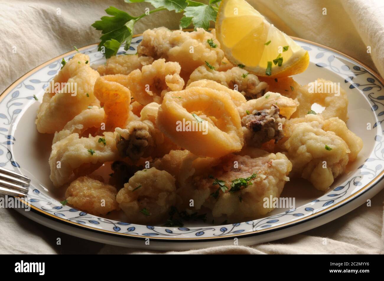 Fried fish dish with lemon slice Stock Photo - Alamy