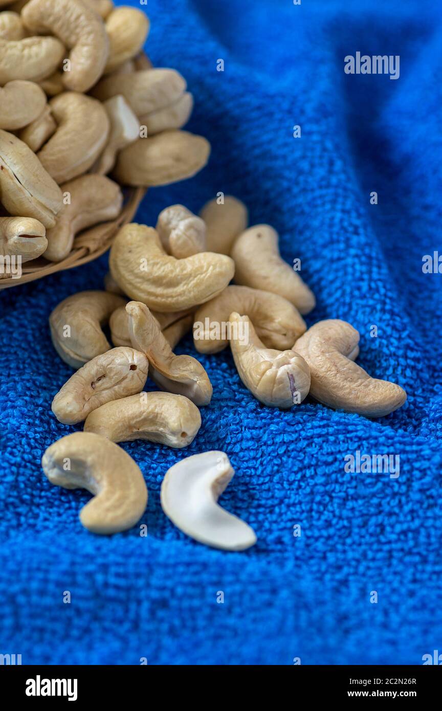 Cashew nuts in basket on blue background Stock Photo - Alamy