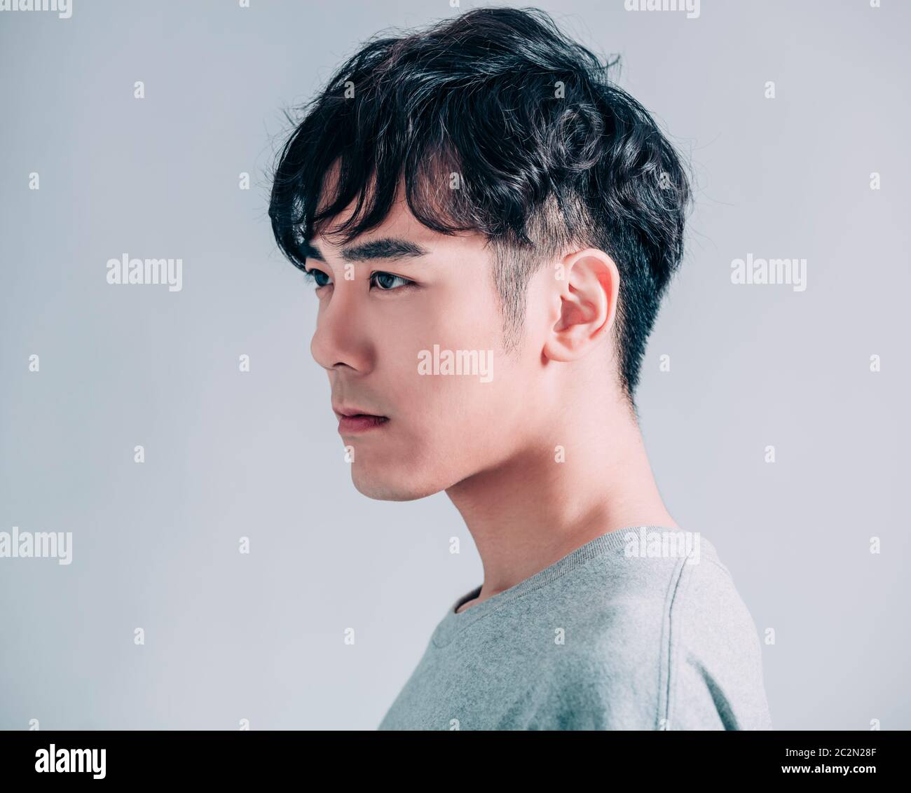 side view of young smiling handsome man isolated on gray background ...