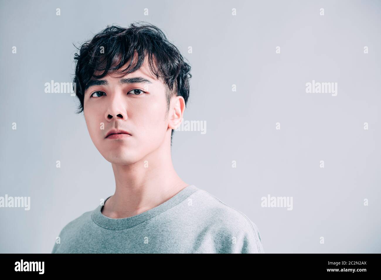 young asian handsome man isolated on gray background Stock Photo - Alamy