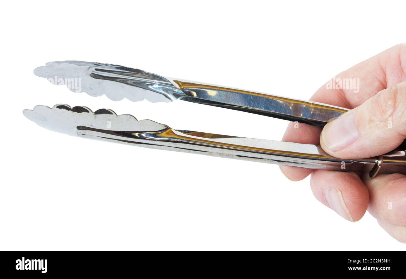 Hand chef holding kitchen tongs Stock Photo - Alamy