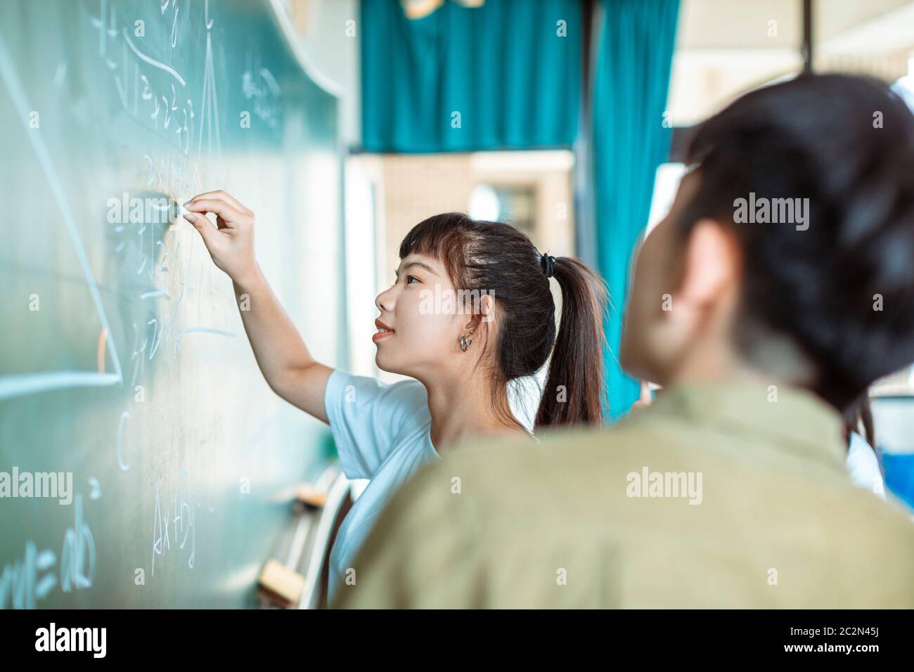 Group of students working on the mathematical problem Stock Photo - Alamy