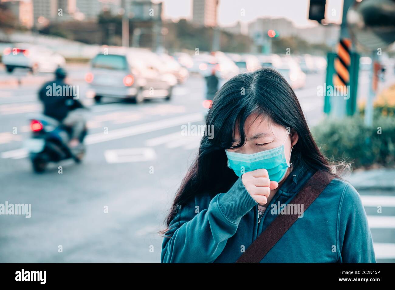 Sick woman with cold and flu walking on the street Stock Photo - Alamy