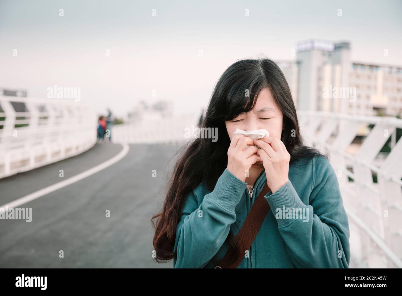 Sick woman with cold and flu walking on the street Stock Photo - Alamy