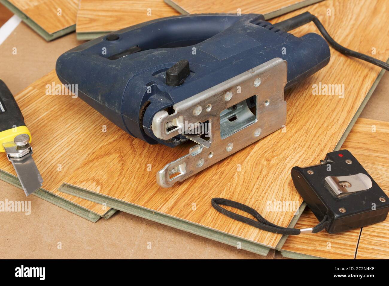 Master using an electric jigsaw saws laminated panel Stock Photo - Alamy
