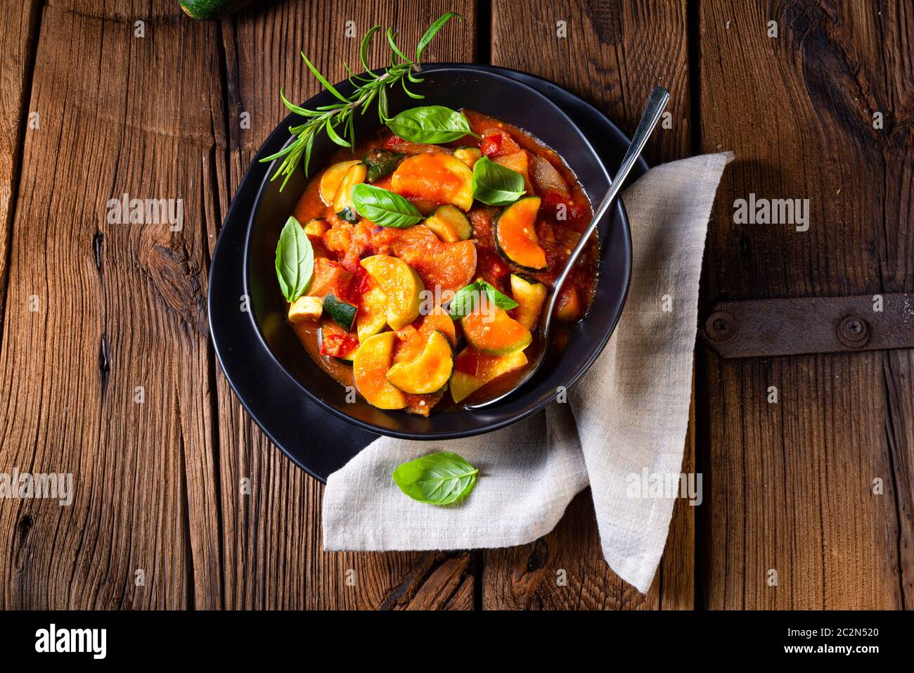 zucchini vegetarian ratatouille with tomato sauce and herbs Stock Photo ...