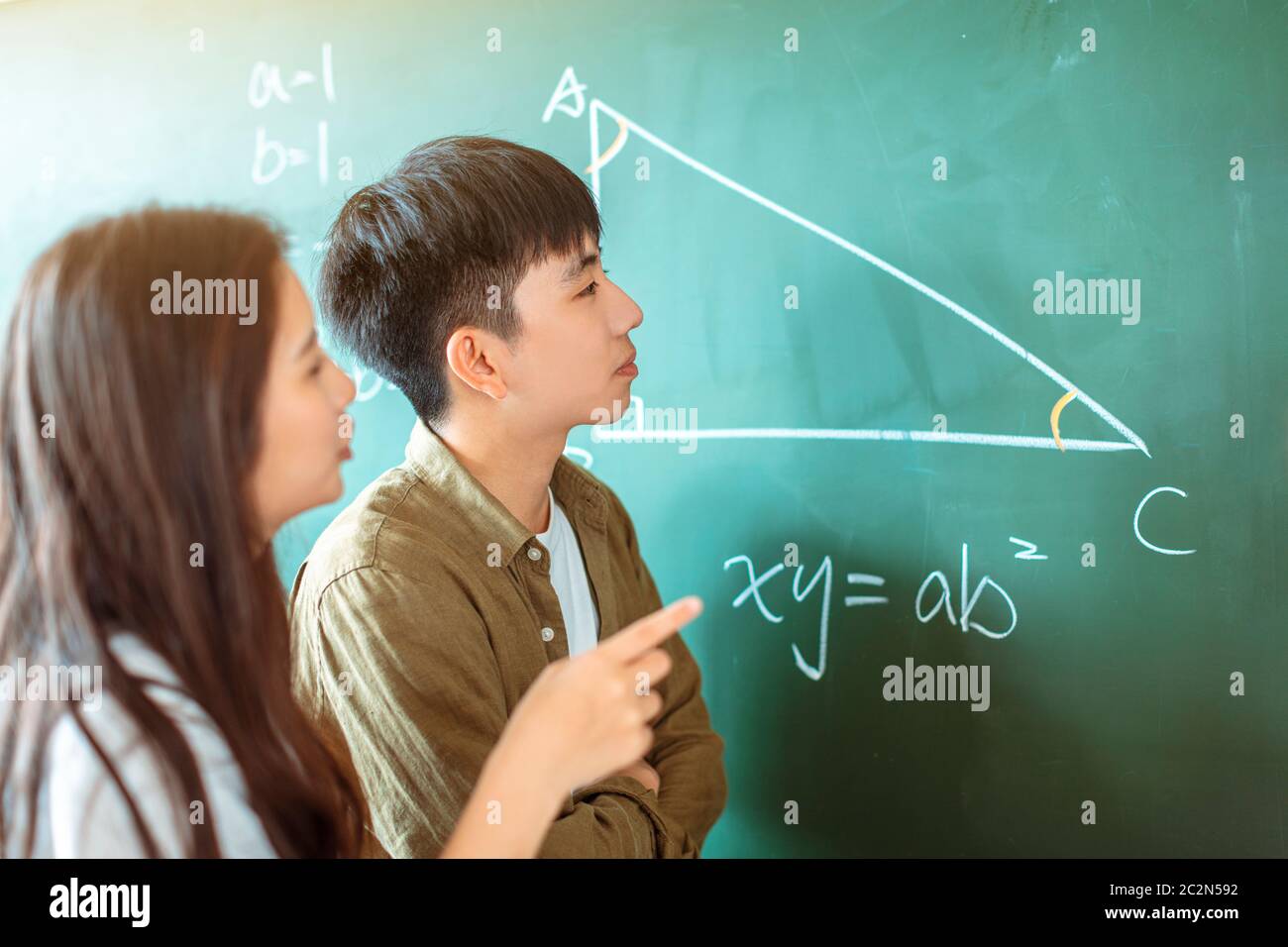Group of students working on the mathematical problem in classroom ...
