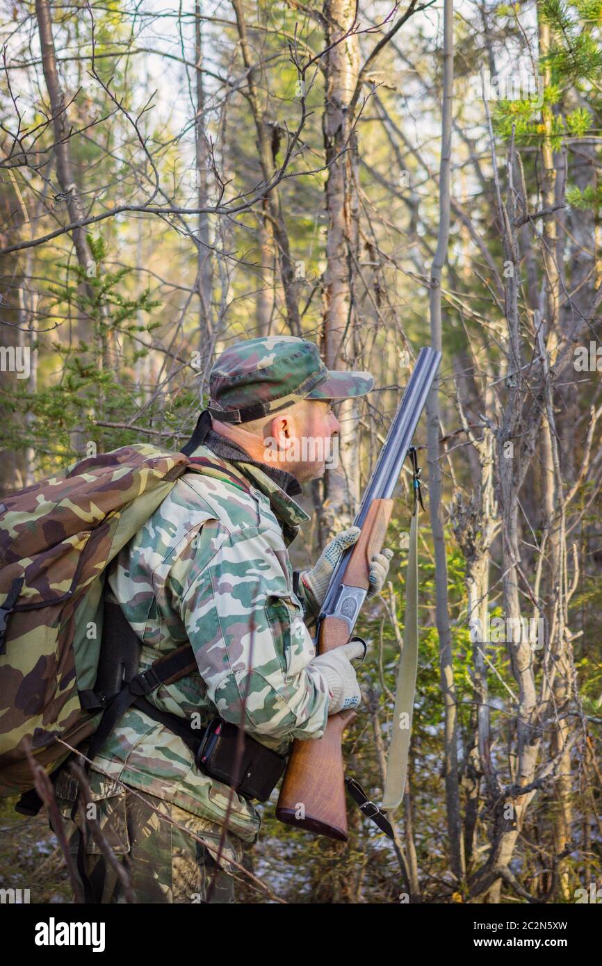 Hunter stalks the bird in the forest Stock Photo - Alamy