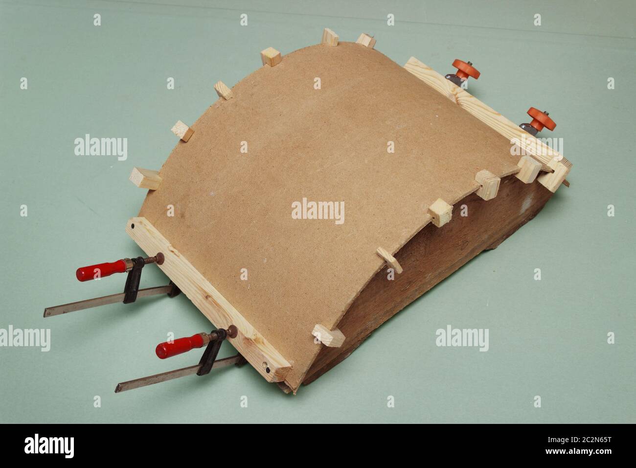Gluing the arch of hardboard with the use of forms Stock Photo - Alamy