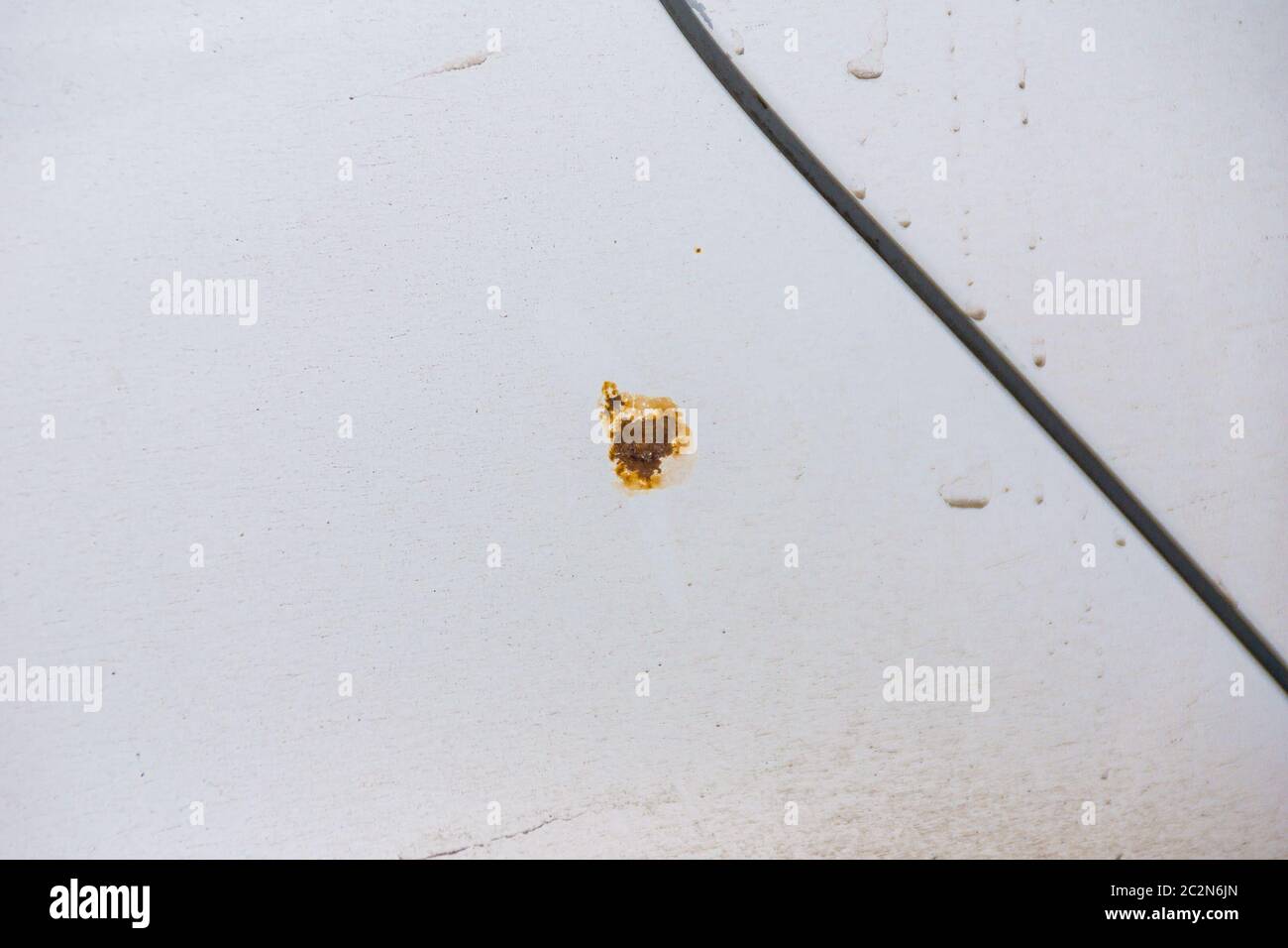 a medium-sized rust stain that has come through a paint coating Stock ...