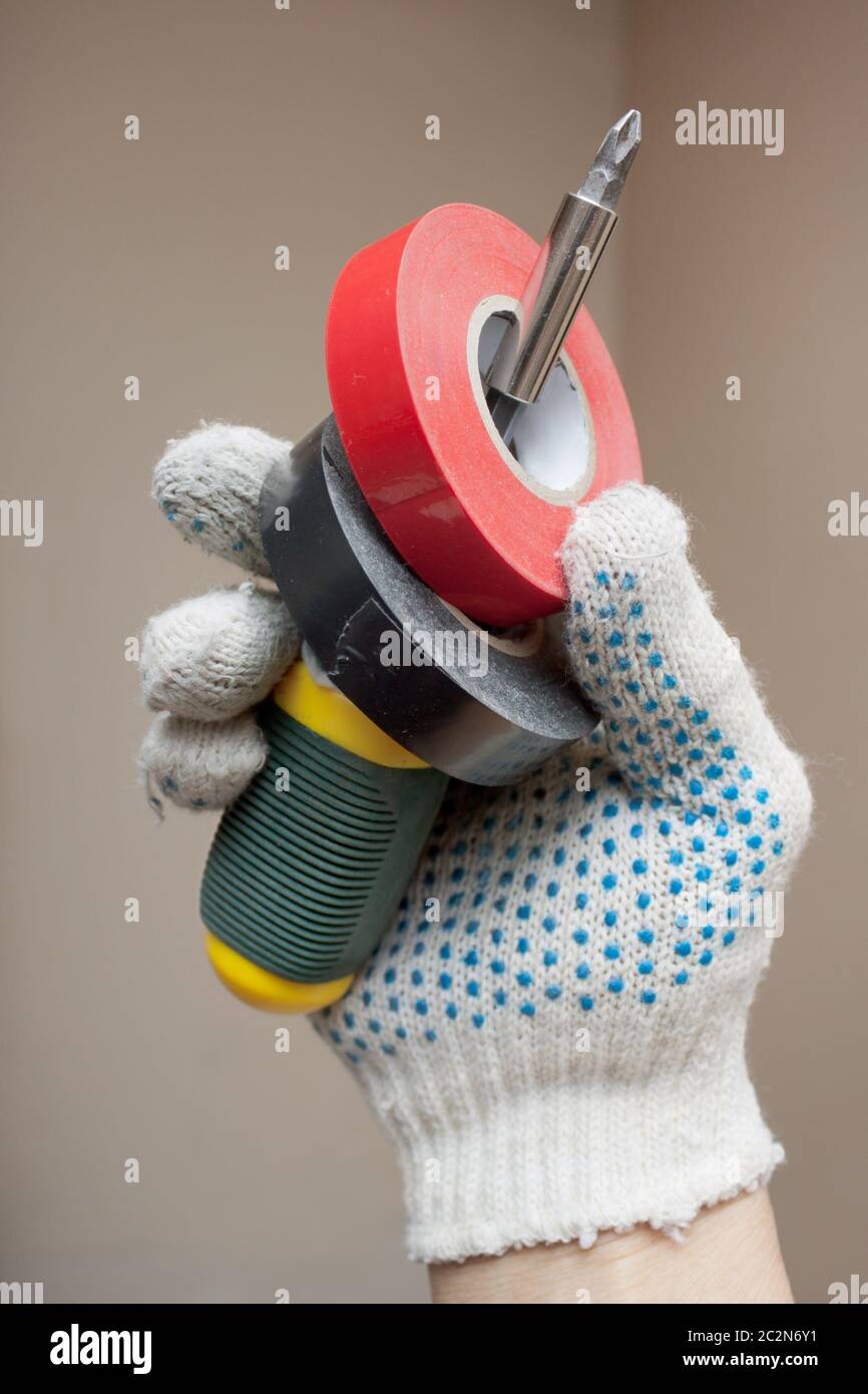 Hand holding screwdriver and electrical tape Stock Photo - Alamy