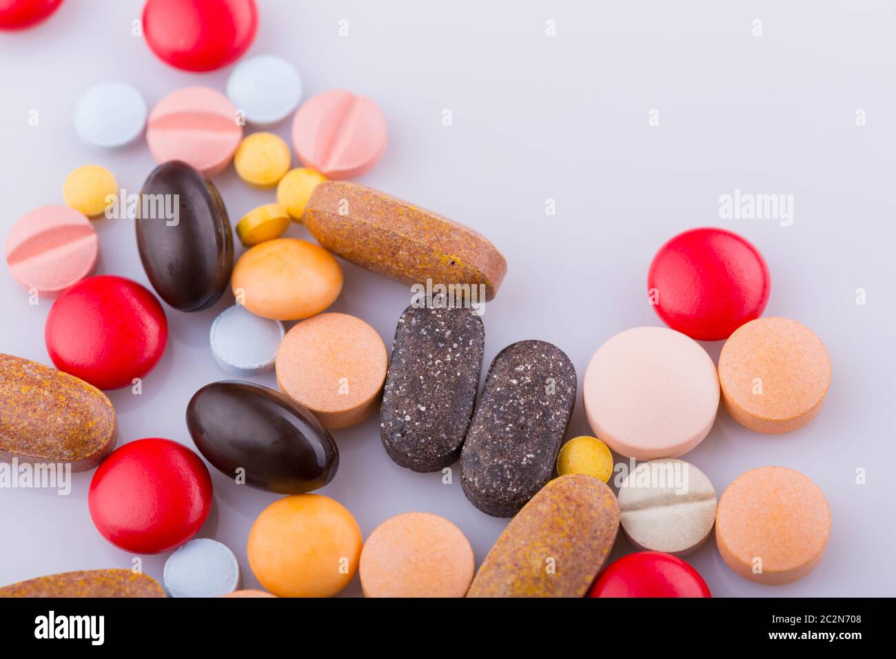Tablets pills capsule heap mix therapy drugs, over a white background ...